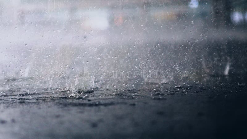 It is Raining Outside. Rain Drops Break in a Puddle Stock Image - Image ...
