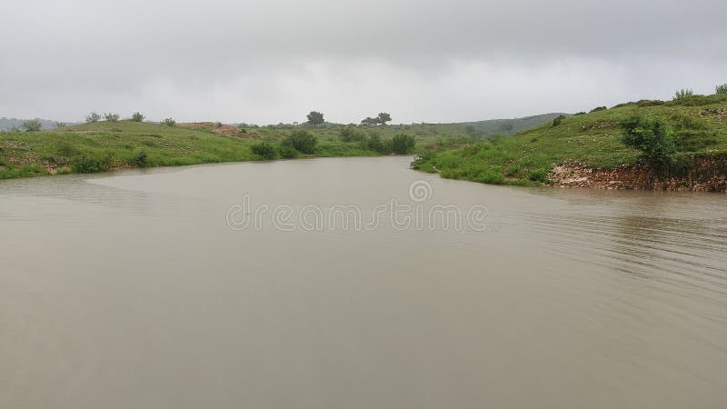 Raining in a Pond Filled with Water Stock Photo - Image of pond, rainy ...
