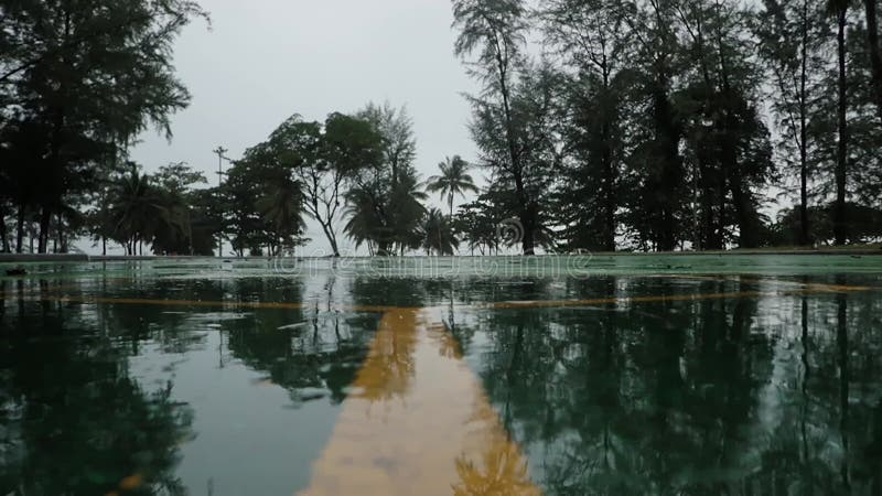 Raining Water Drops Falling into Small Puddle on Cement. Stock Footage ...