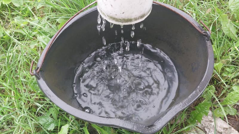 Rainwater Dripping from a Drain into a Bucket Stock Footage - Video of ...