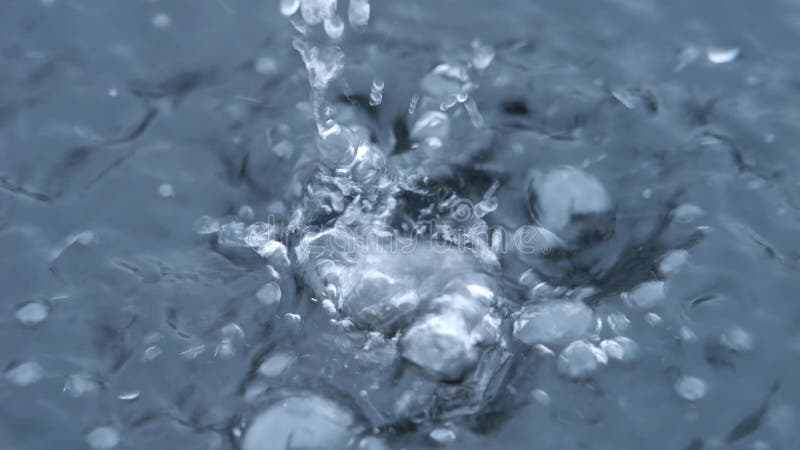 Rainwater Drops Drip into a Puddle. a Close-up of the Drain. Raindrops ...