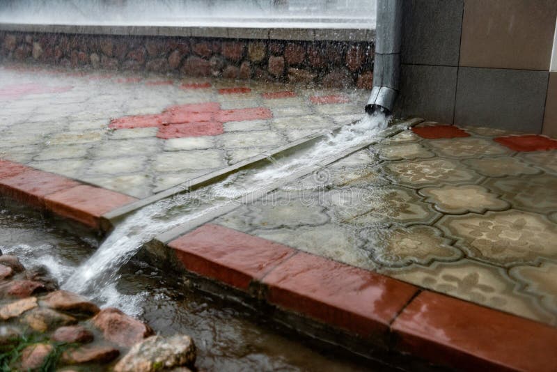 Rainwater Flows from the Gutter during a Heavy Rain. Stock Image ...