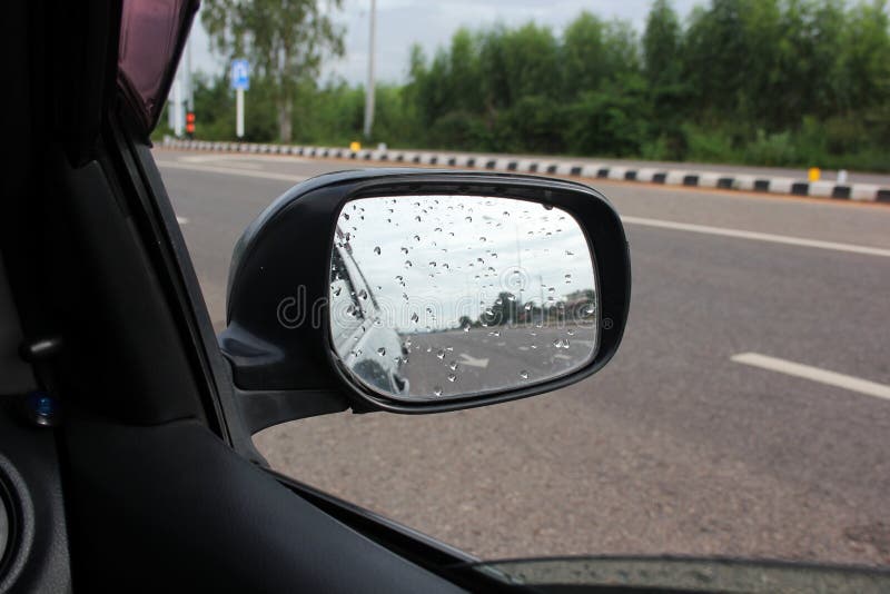 Car Side Mirror with Rain Drops on Car Window on White Cloud Background ...