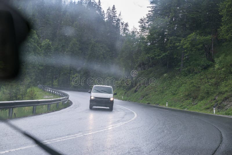 Rainy Road Surface and Raindrops on a Car Windshield Stock Image ...