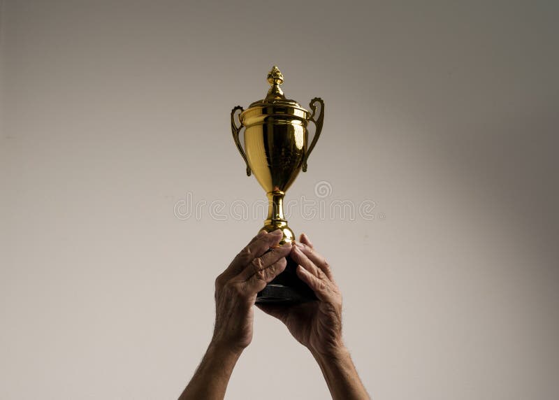 Raised Hands of Old Man Holding Trophy. Isolated, Close Up Stock Image ...