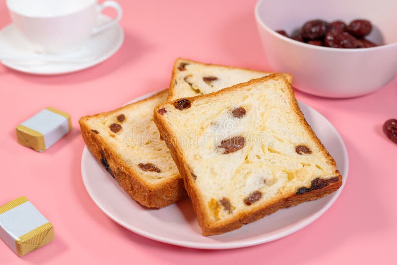 Raisin Toast, Butter and Tea Cup Placed on Pink Table Stock Photo ...