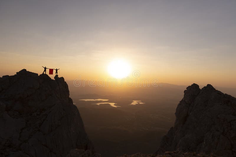 Raising the Flag at the Top after a Tough Climb and Achieving Stock ...