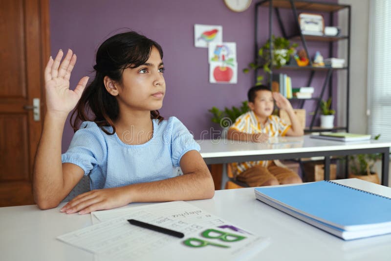 Raising Hand during Classroom Lesson in Elementary School Stock Photo ...