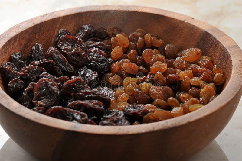 Raisins in a wooden dish stock photo. Image of pattern - 75182344