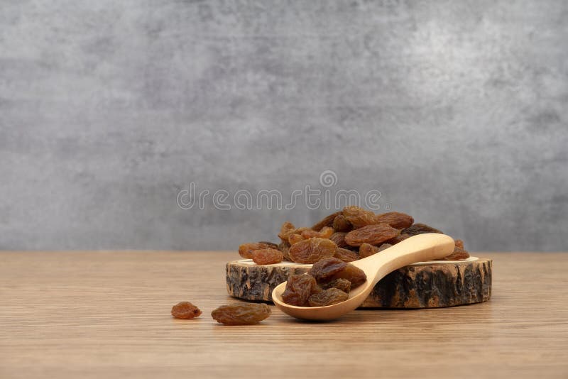 Raisins and Wooden Tray on Wooden Texture Background. Dry Raisins Stock ...