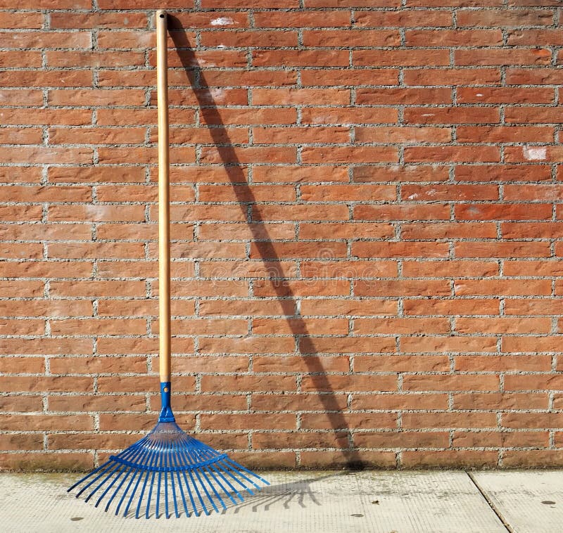 Rake on a brick wall stock photo. Image of detail, house - 90541830