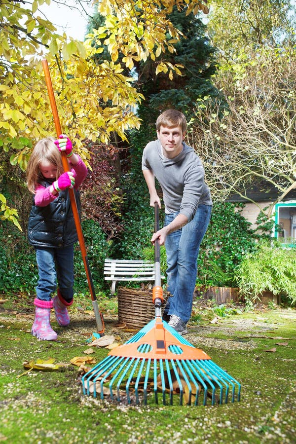 Raking the autumn leaves stock photo. Image of change - 1398852