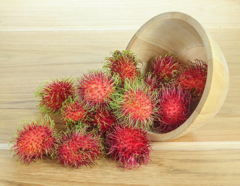 Rambutan on wood table stock photo. Image of dessert - 175315462