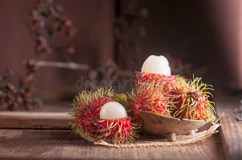 Rambutan on wood table stock photo. Image of negrito - 94499424