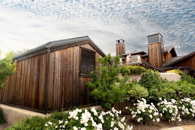 Ranch-style Home on a Cloudy Day Surrounded by White Flowers Stock ...