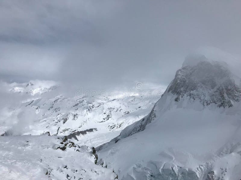 Range of High Mountain Peaks Covered in Snow in the Mist Stock Image ...