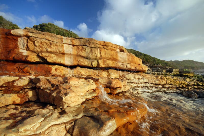 Rapahoe Beach rocks stock photo. Image of sandstone, yellow - 16090082