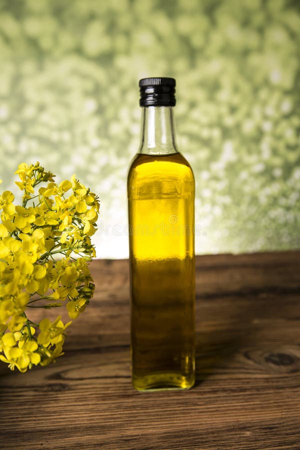 Rapeseed Flowers and Rapeseed Oil in a Bottle on the Table Stock Image ...