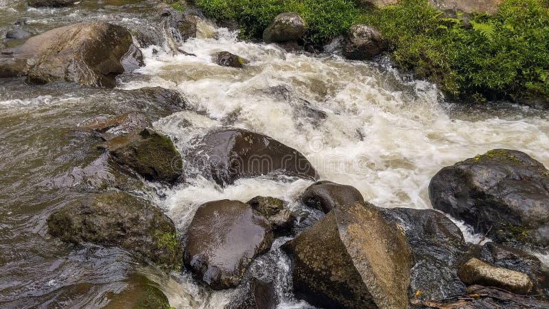 The Rapid Flow of Waterfall Water Hits a Large Rock Stock Image - Image ...