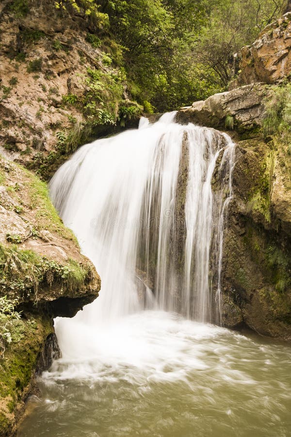 A Rapid Mountain Stream of Water Forms a Large Waterfall. the Stream of ...