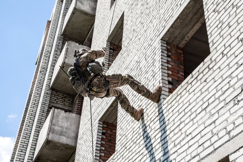 Rappeling with weapons stock photo. Image of extraction - 59572902