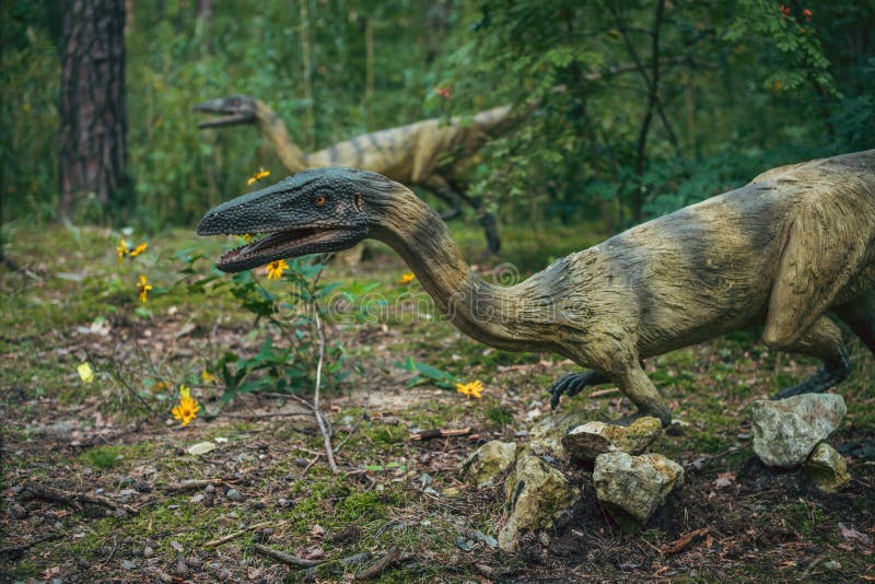 Raptor dinosaurs statues editorial photo. Image of fossil - 102113571