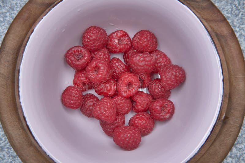 Raspberries in a bowl stock image. Image of fresh, juicy - 154886241