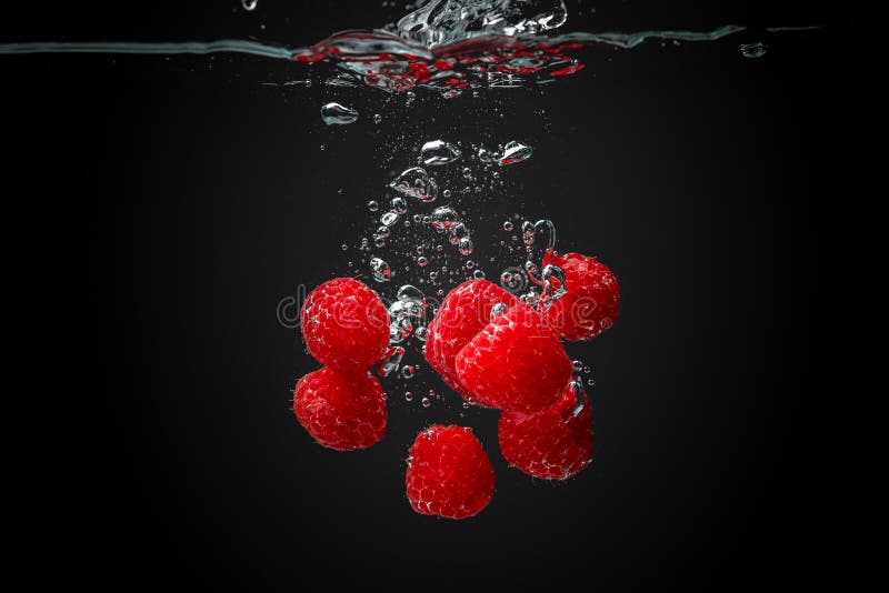 Raspberries Falling Into Crystal Clear Water Stock Image - Image of ...