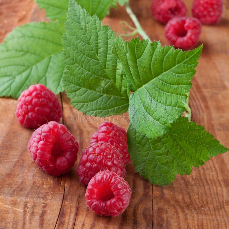 Raspberries with Leafs on Wooden Background Stock Photo - Image of ...