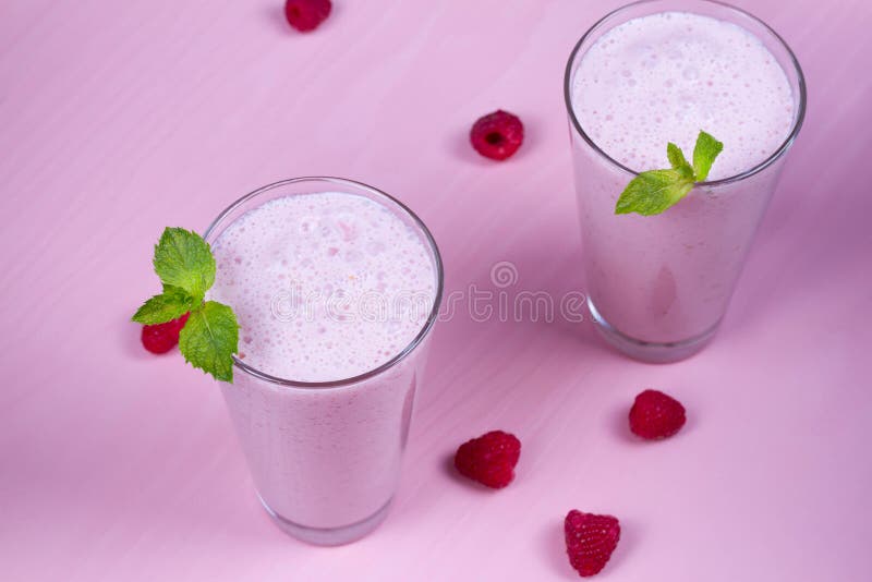 Raspberries Milkshake Garnished with Mint on Pink Wooden Background ...