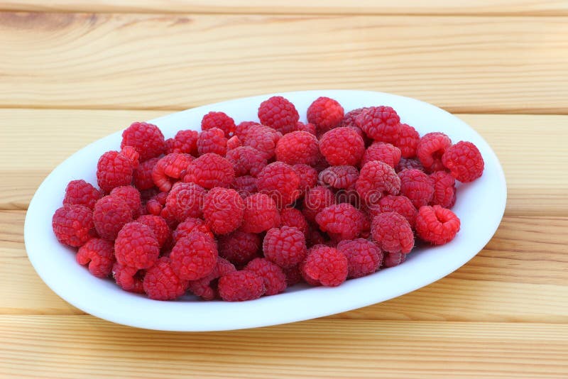 Raspberries in plate stock photo. Image of oval, plate - 34624092
