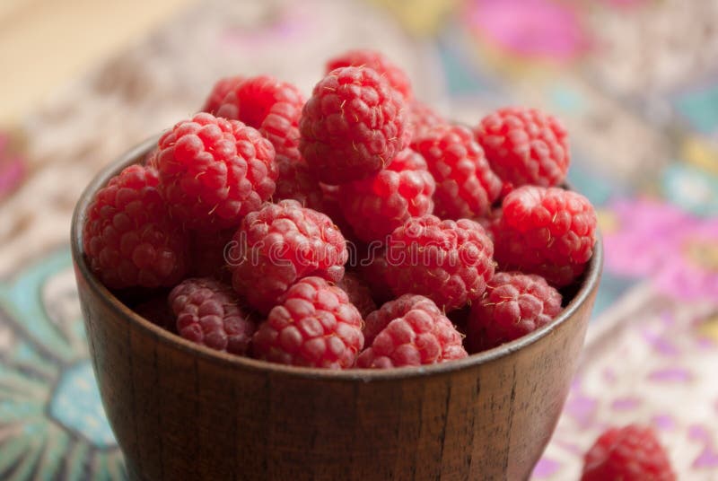 Raspberries in wooden bowl stock image. Image of table - 56824267