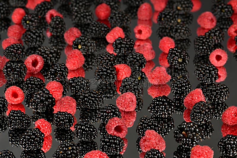 Raspberry and Blackberry on Black Mirror. Side View. High Resolution ...