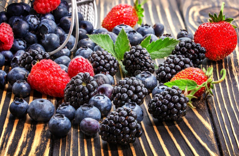 Raspberry, Blackberry and Blueberry on a Wooden Table. Stock Photo ...