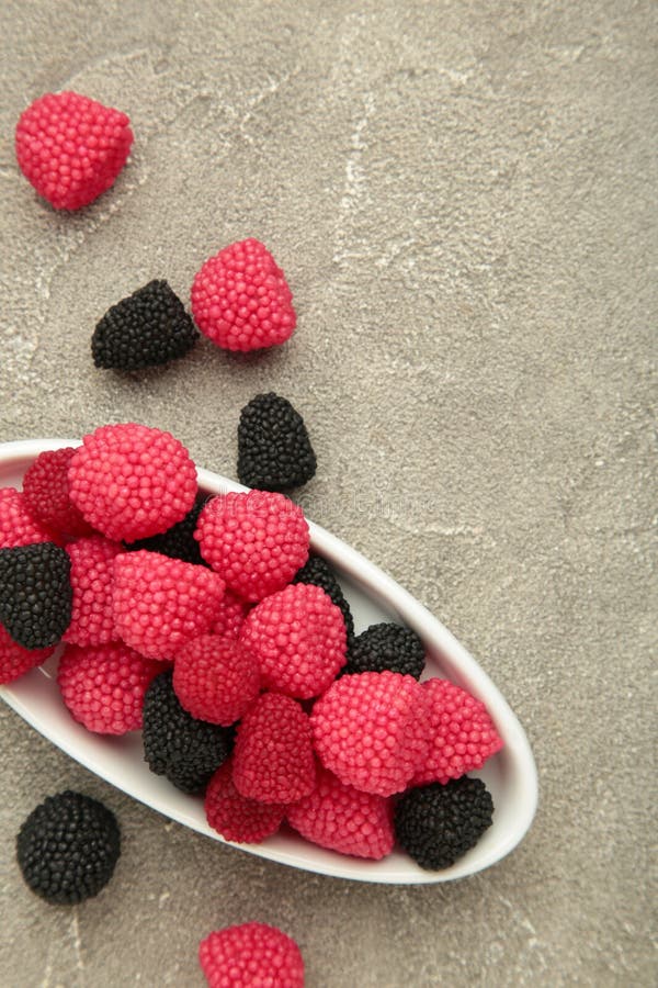 Raspberry and Blackberry Candy on Plate on Grey Background. Vertical ...