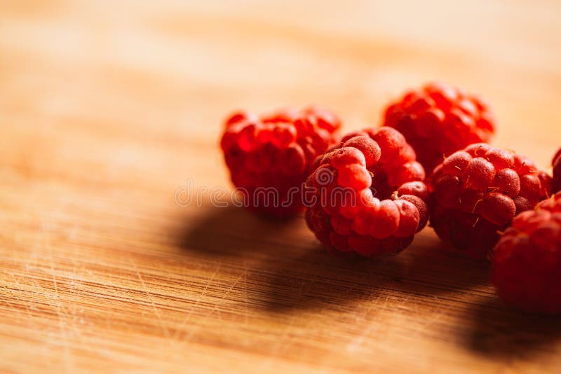 Raspberry on a Blurred Background of Wooden Planks Stock Photo - Image ...