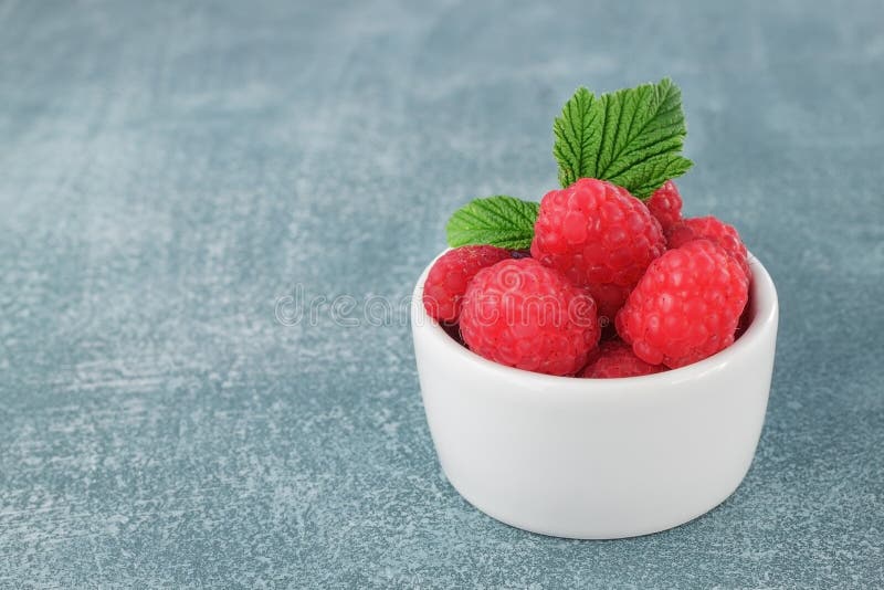 Raspberry in Bowl. Raspberry on Blue Bacground with Copy Space for Text ...