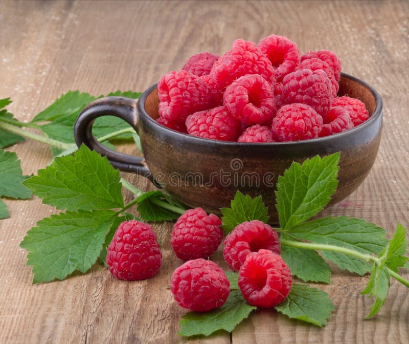 Raspberry in a Cup on Wooden Background Stock Photo - Image of ...