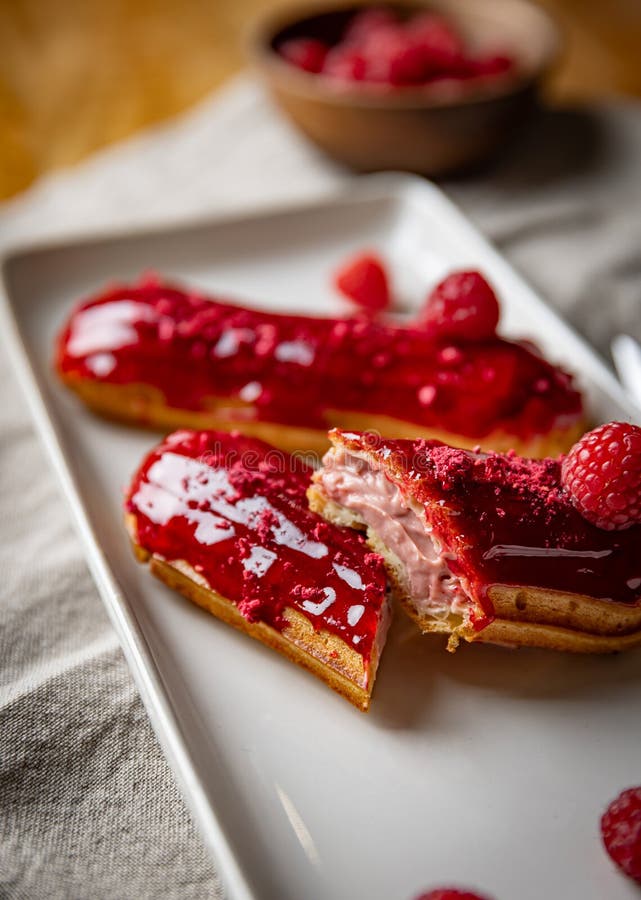 Raspberry Eclairs with Red Raspberry Icing Stock Photo - Image of ...