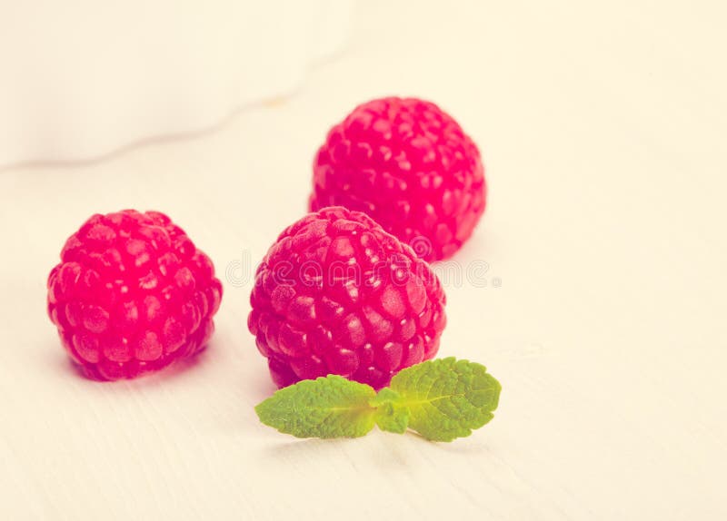 Raspberry Green Leaves and White Bowl. Toned in Warm Colors Stock Photo ...