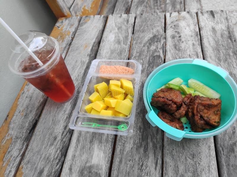 Raspberry Iced Tea with Fish Cake and Pickled Mango. Stock Image ...