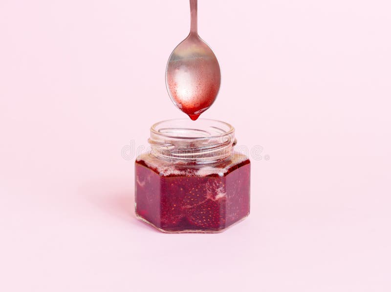Raspberry Jam Dripping from a Spoon into a Small Glass Jar. Stock Image ...