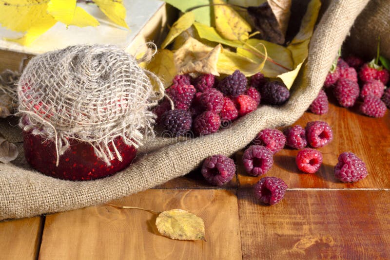 Raspberry Jam and Fresh Raspberry on a Rustic Wooden Table Outdoors ...