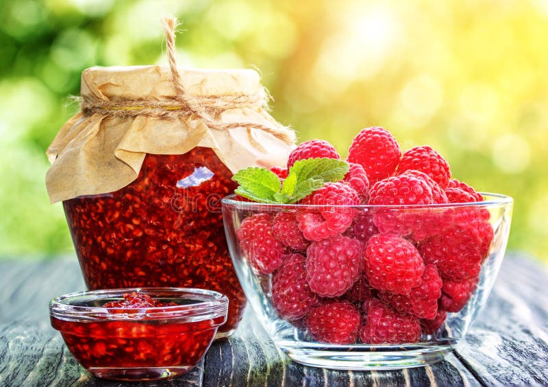 Raspberry Jam and Fresh Raspberry on a Wooden Table Outd Stock Photo ...