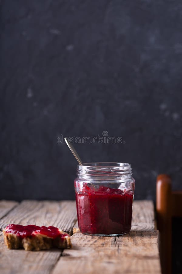 Raspberry Jam in a Jar on a Black Background in Rustic Style Stock ...