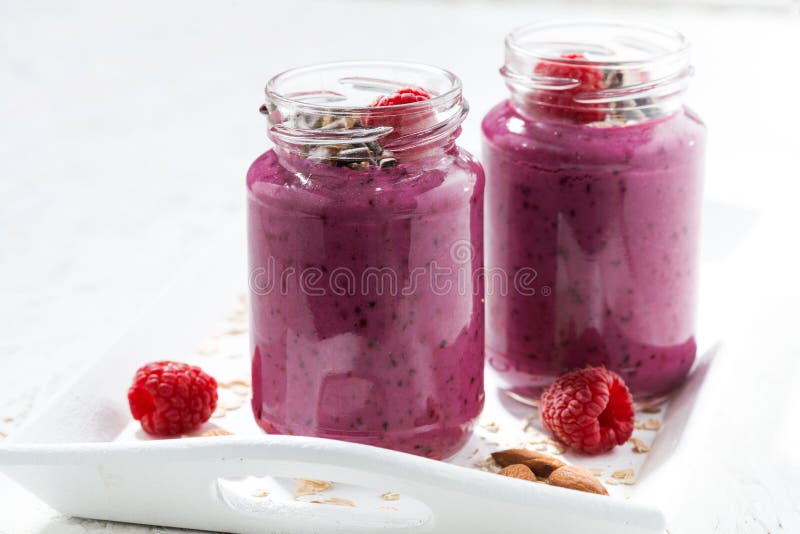 Raspberry Smoothie with Oatmeal and Chocolate on White Table Stock ...