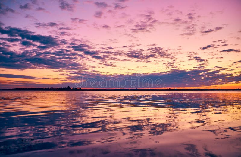 Raspberry Sunset on the Shore. Mirror Reflection of a Cloudy Sky in the ...