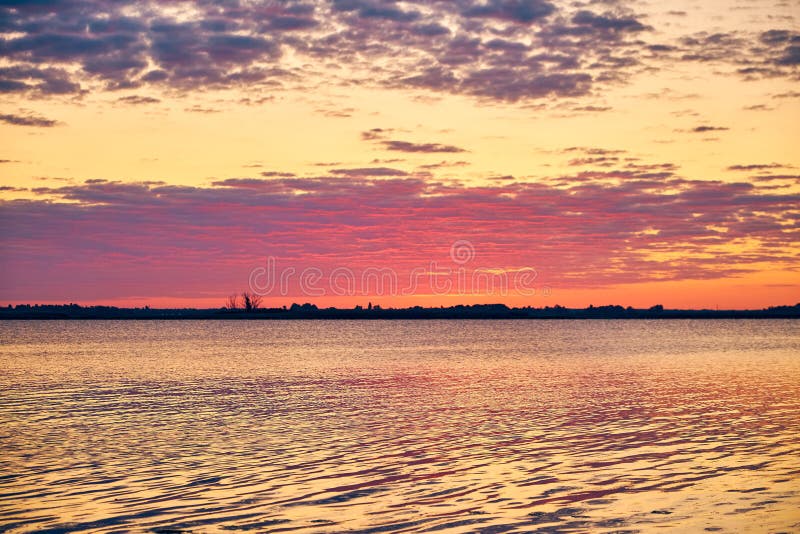 Raspberry Sunset on the Shore. Mirror Reflection of a Cloudy Sky in the ...