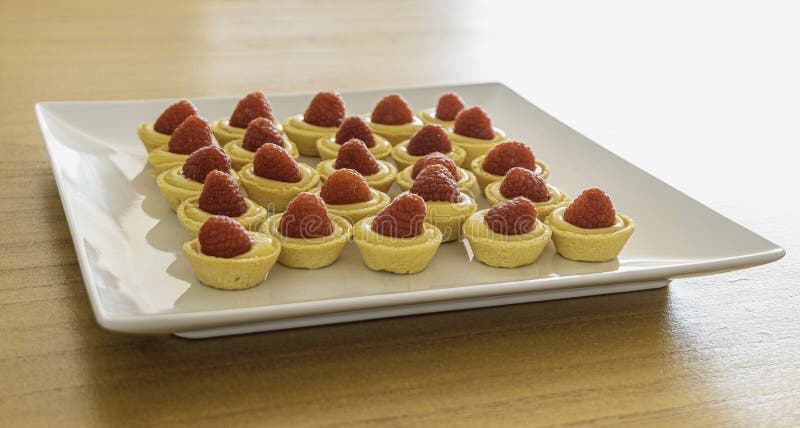 Raspberry Tartlets with Lemon Curd on a White Ceramic Plate. Elegant ...