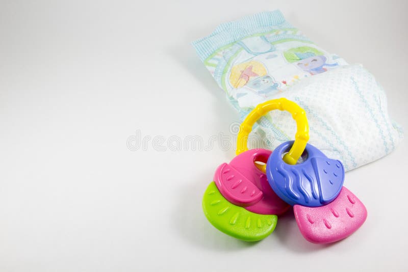 Rattle and Diaper on a White Background Stock Image - Image of diaper ...